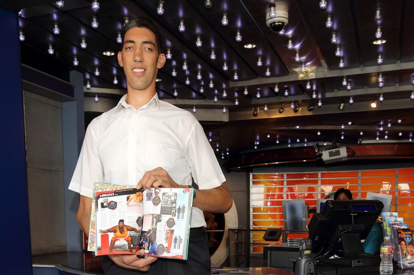 World's tallest man who stands at 8ft 2in needs three beds and travels ...