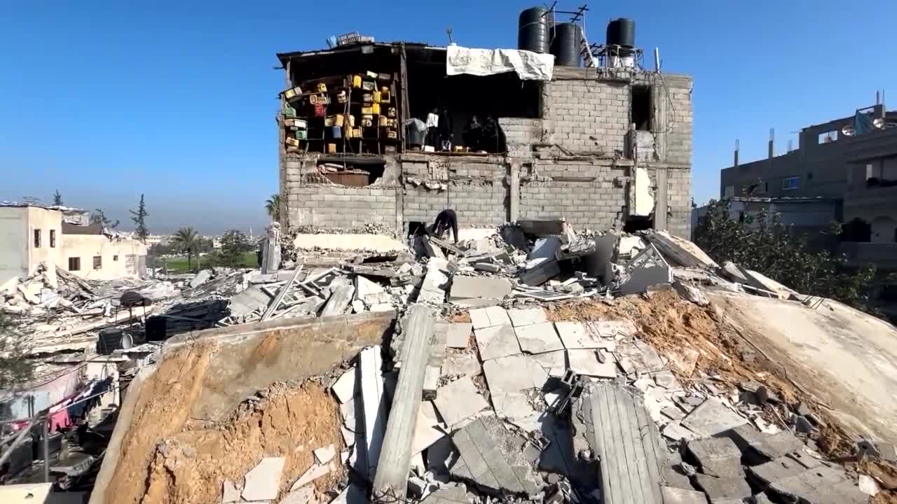 War-damaged building collapses in central Gaza, killing two