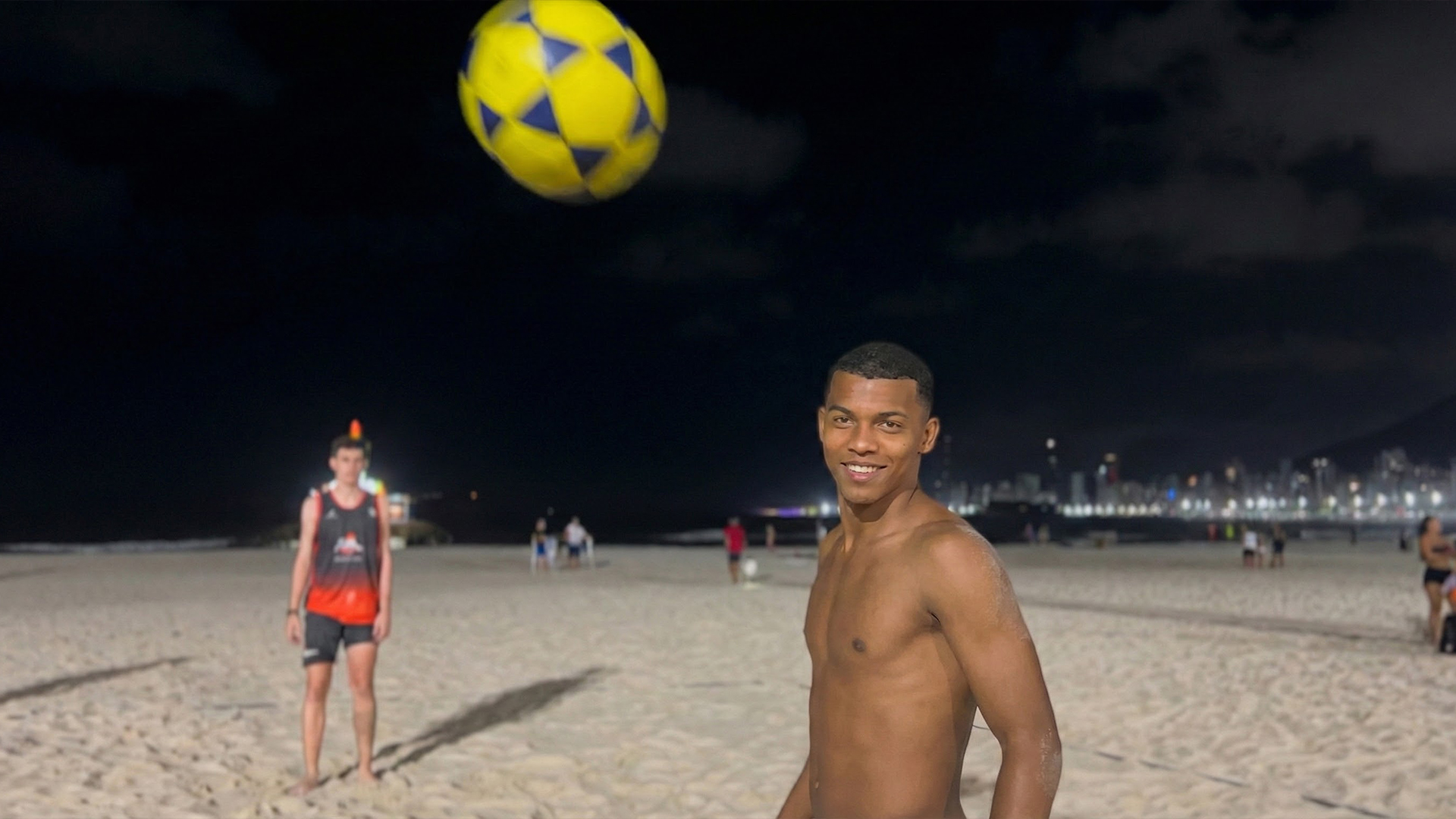 Funny Brazilian footballer keeping up on the beach