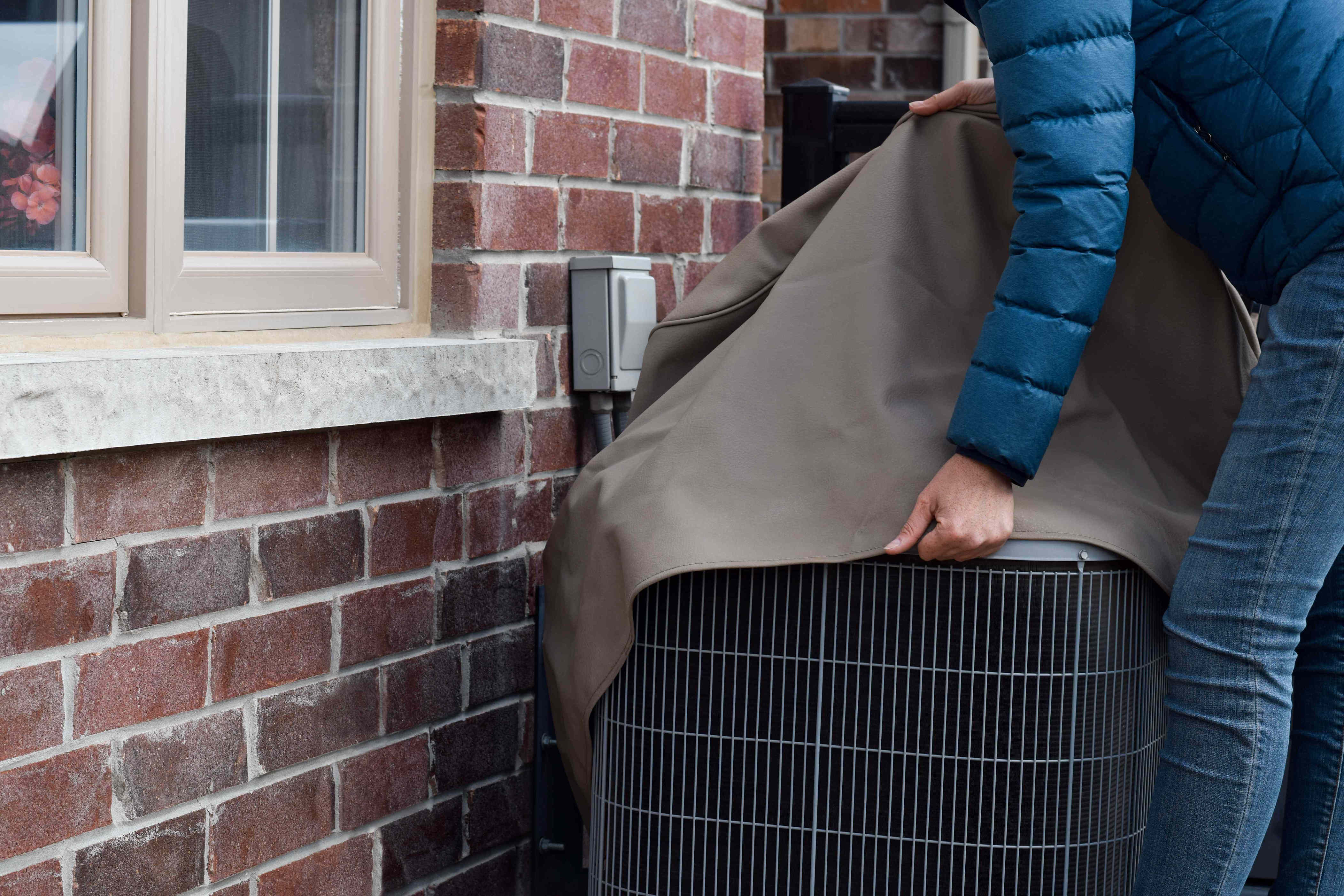 Should you cover your AC unit for the winter? Here’s what experts say