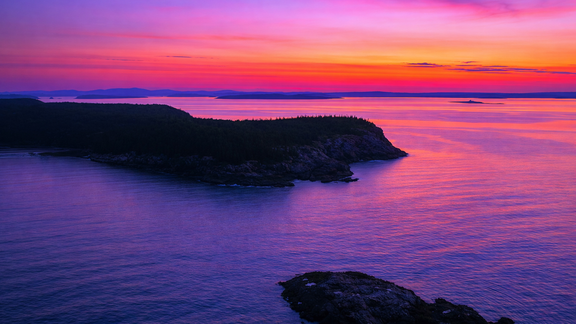 Calm waters reflecting sunset glow