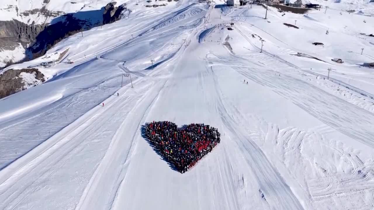 Skiers form giant heart in snow for Swiss resort fire victims
