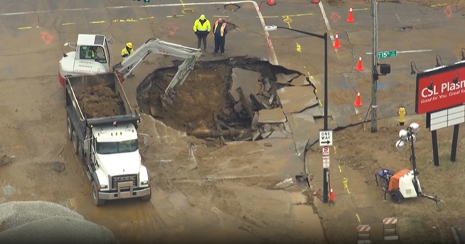 Aerials: Water main break opens up massive hole at west Louisville ...