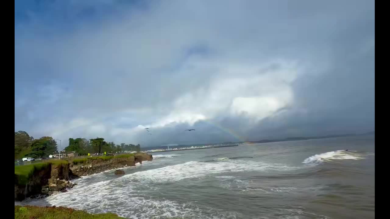 Double rainbow forms over coastal cliffs in Santa Cruz, California, USA