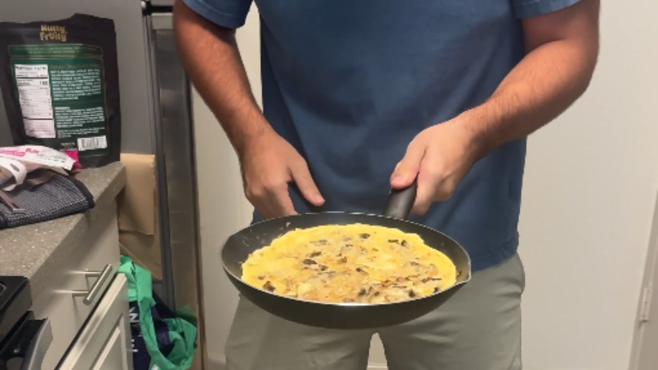 Gentleman takes ages to flip omelet and still drops half on the floor