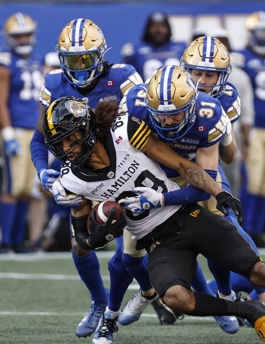 Tiger-Cats re-sign lineman Revenberg; Bombers extend defensive back Holm