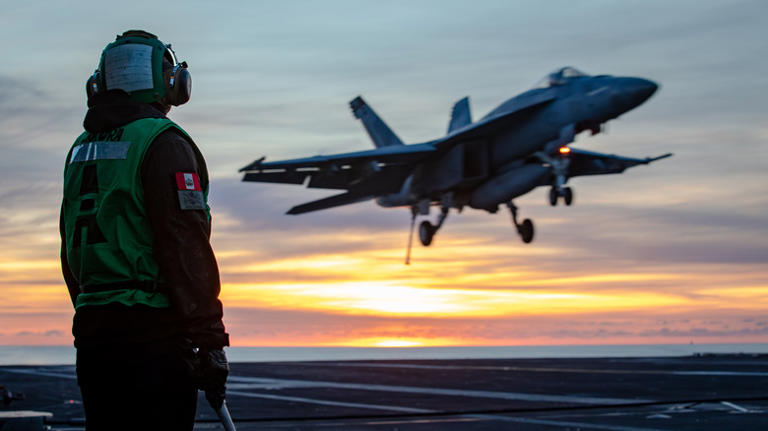 Do US Navy pilots use autopilot to land jets on aircraft carriers?