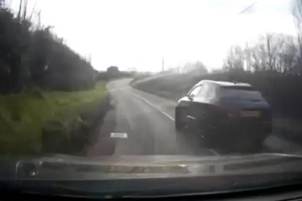 Watch - 'Lunatic driver' overtakes car before crashing into hedge
