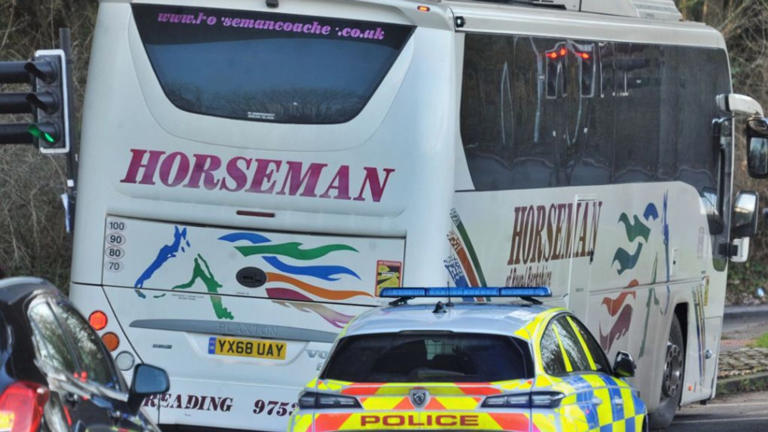 School bus crashes into ditch after slipping on black ice - as nine ...