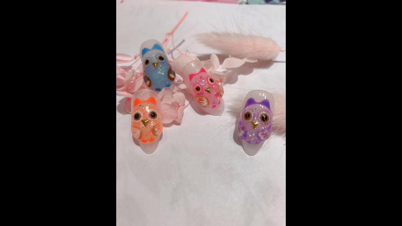Creating nail art with cute owl motifs in pastel and neon colors