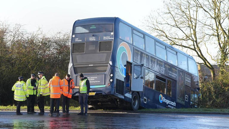 School bus crashes in ditch 'after black ice skid'