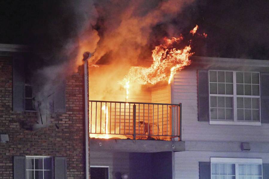 Heroic neighbor scales building to rescue woman from fiery balcony; cat ...