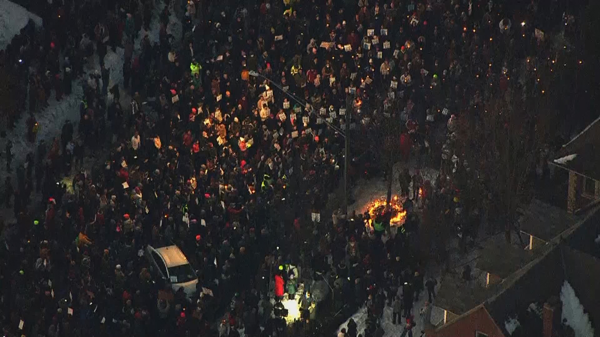 Hundreds gather for a vigil at the scene where a woman was shot and ...