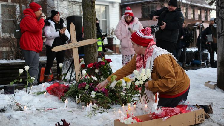 Thousands gather for a vigil at the scene where a woman was shot and ...