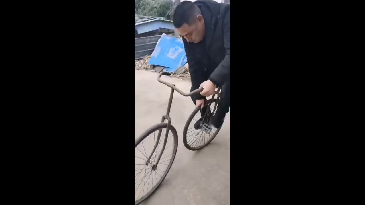 Man attempts to ride a detachable split bicycle in Jiangsu, China