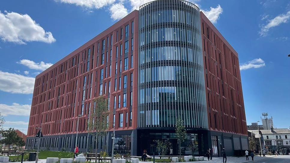 DWP office evacuated after cladding falls to ground