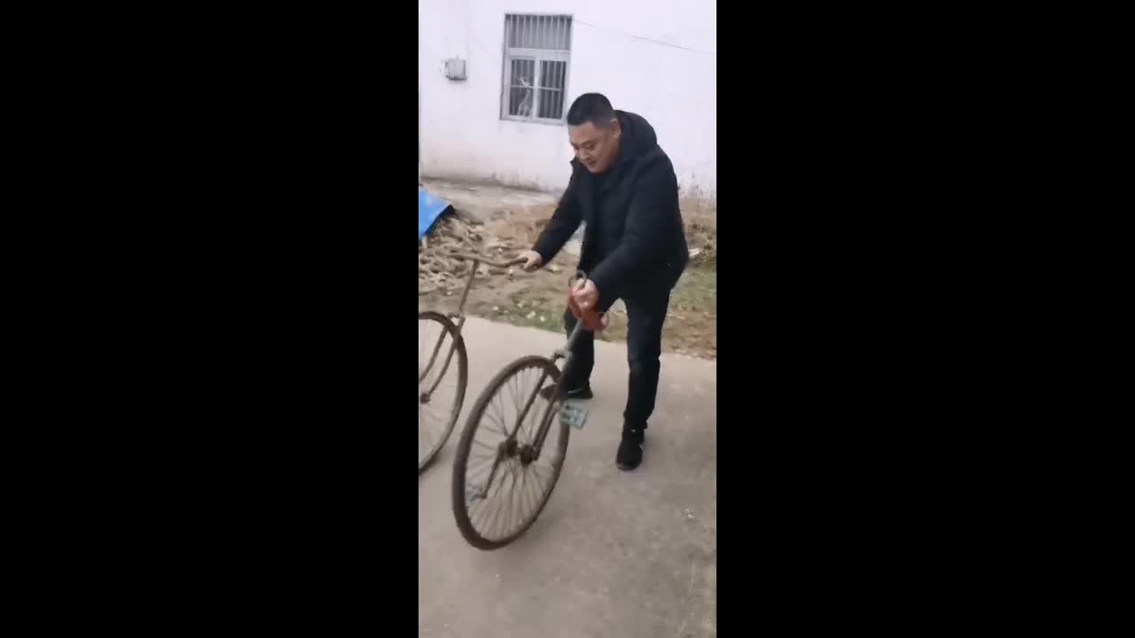 Man attempts to ride a detachable split bicycle in Jiangsu, China