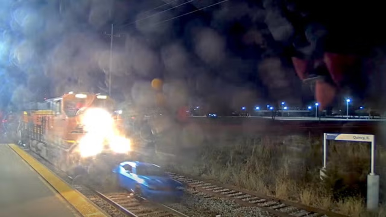 A Dodge Challenger Hellcat gets stranded on tracks as a freight train ...