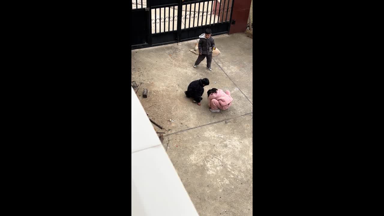 Firecracker mishap startles children and dog outside a home in Hunan, China
