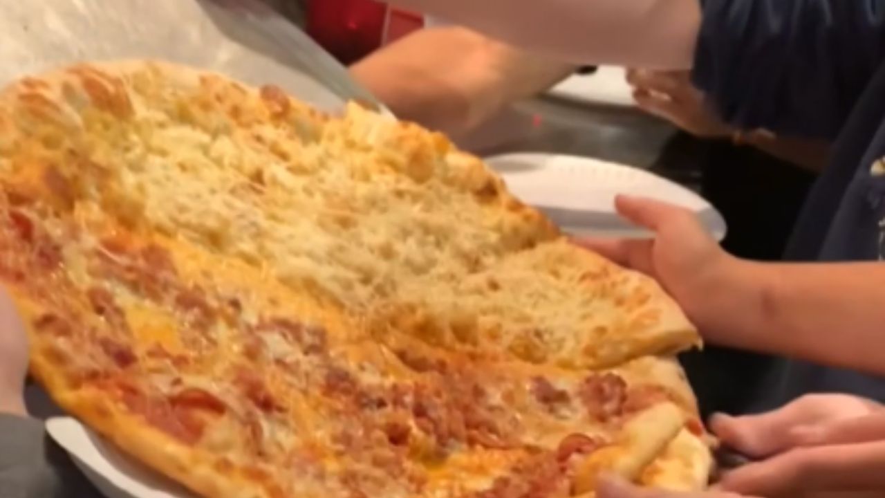 Woman watches her Hell's Kitchen pizza fall as the pan suddenly tips ...