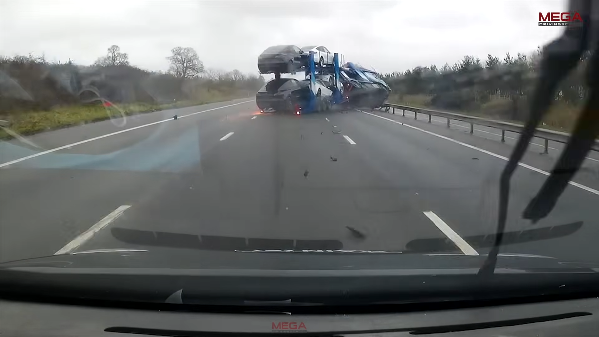 Car carrier overturns in violent highway crash