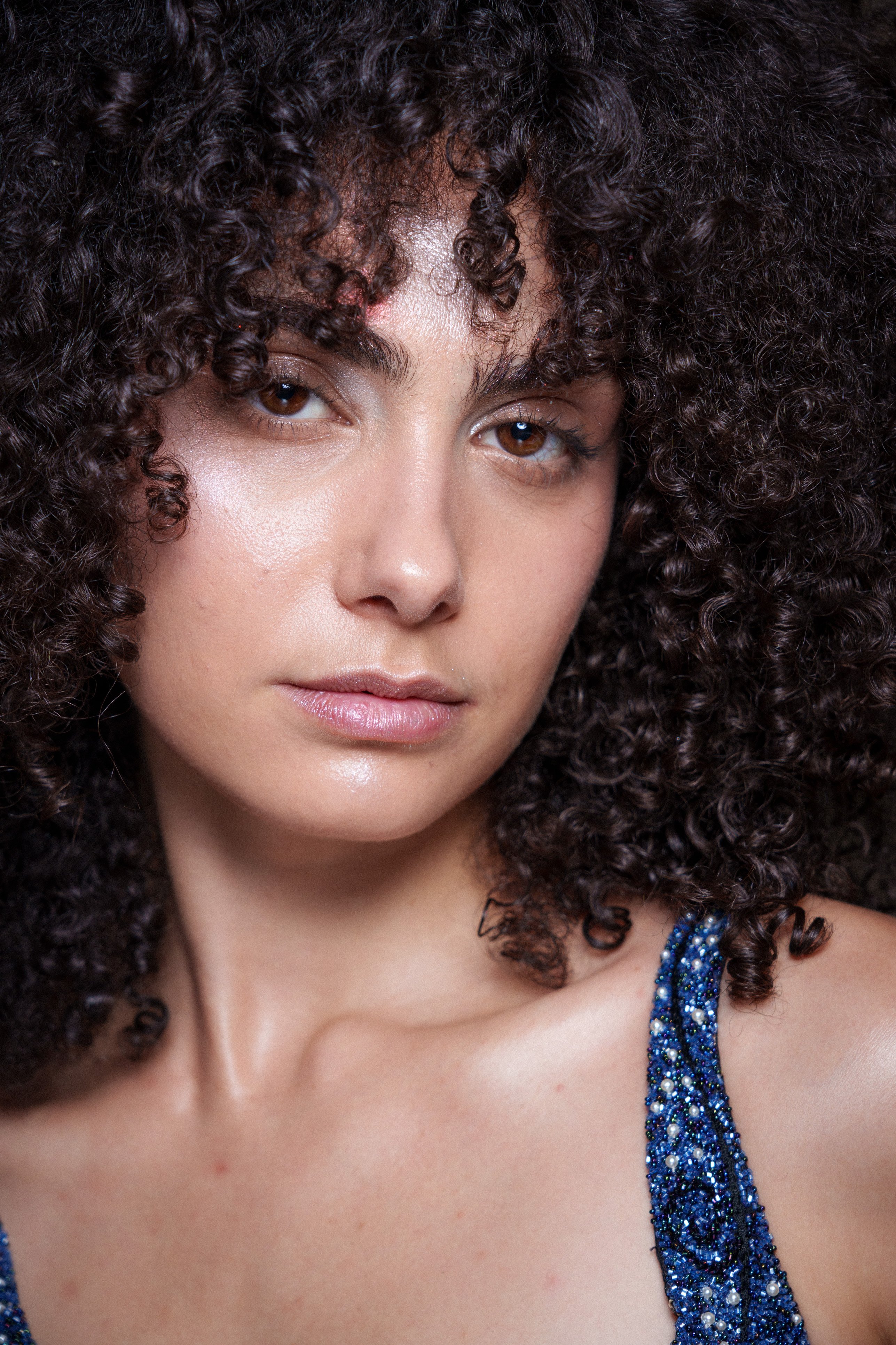 Everything you need to know about styling curly bangs
