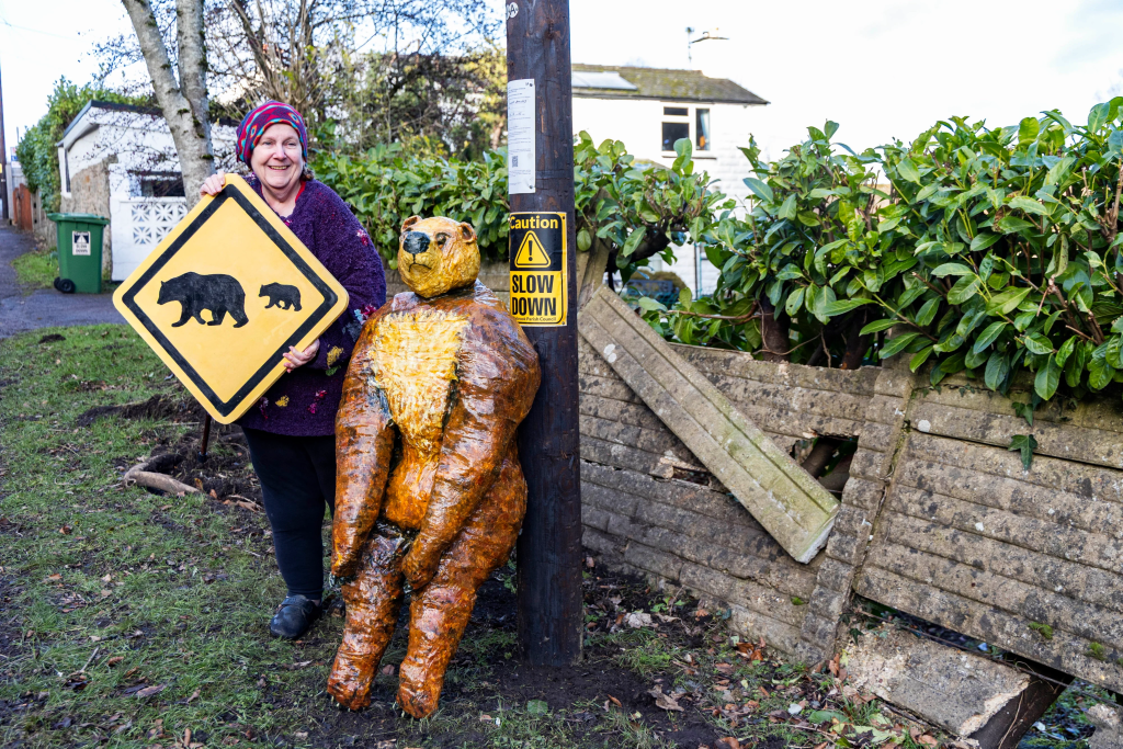 Woman installs 'bear warning' signs to stop drivers from crashing into home