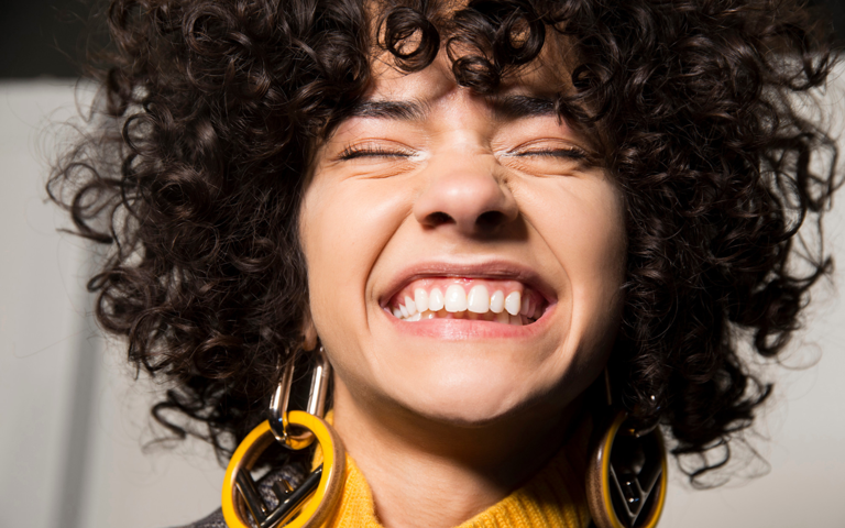 Everything you need to know about styling curly bangs