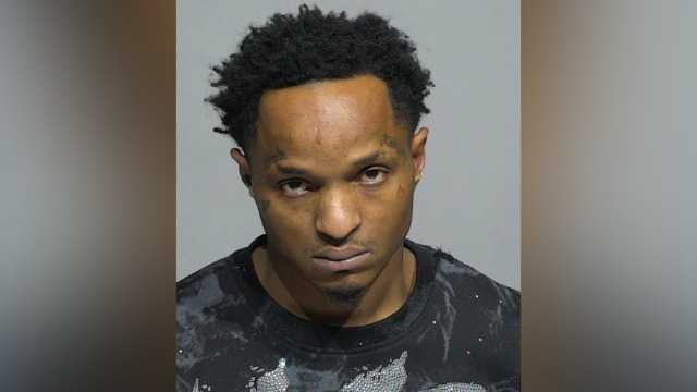Milwaukee police officer trapped in car of wanted man