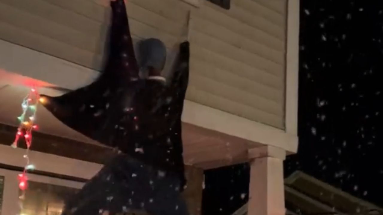 Mom and kids team up to set up a Christmas display that looks like a ...