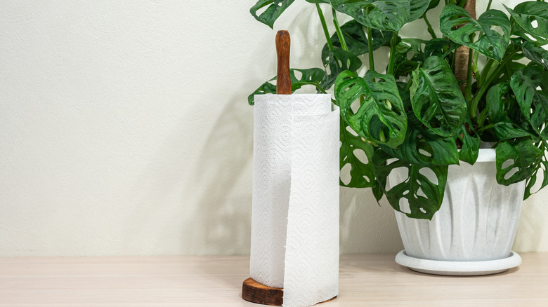 Store extra toilet paper rolls with a simple paper towel holder solution