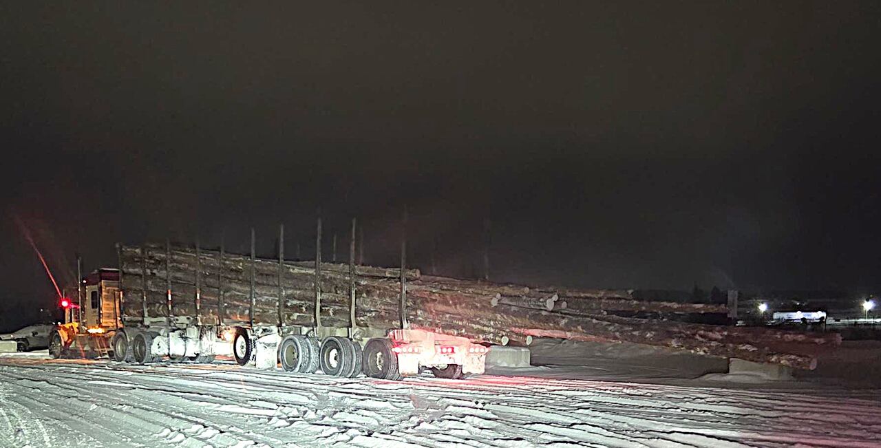 Long log load leads to charges for trucker, owner