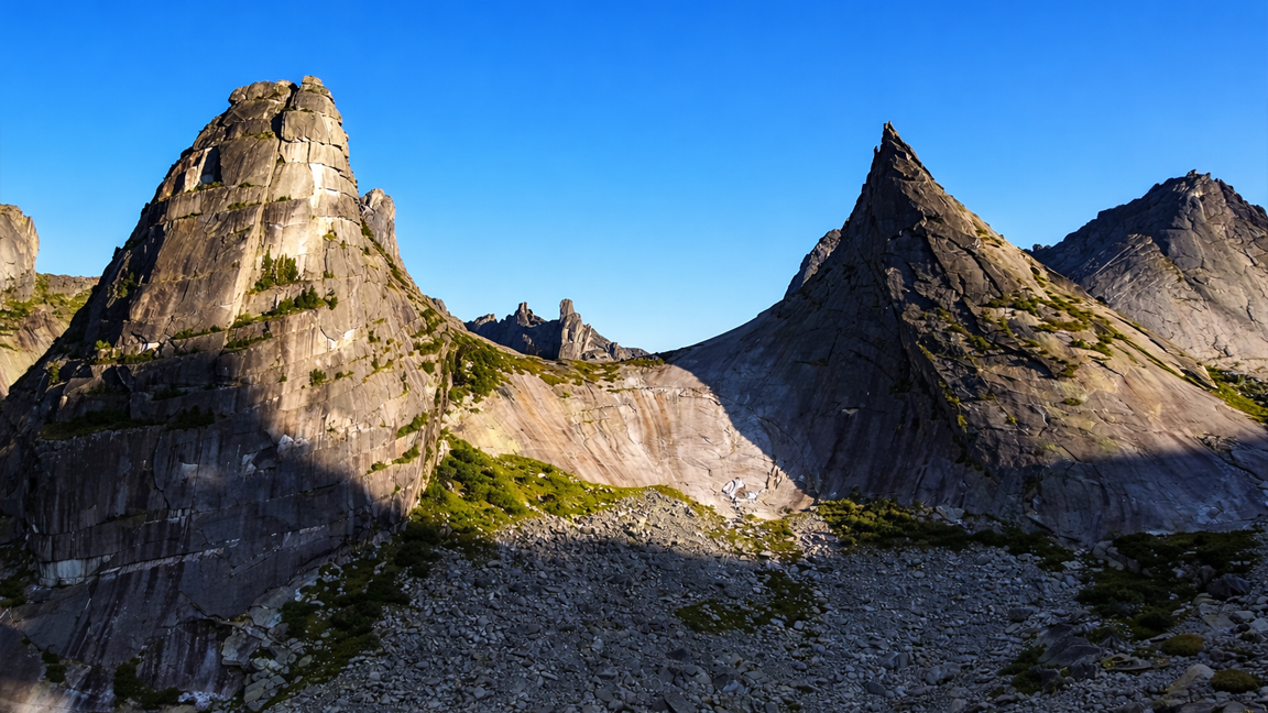 Sharp rocky peaks under clear blue sky