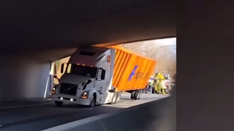 A low bridge trapped a tractor-trailer with no clearance