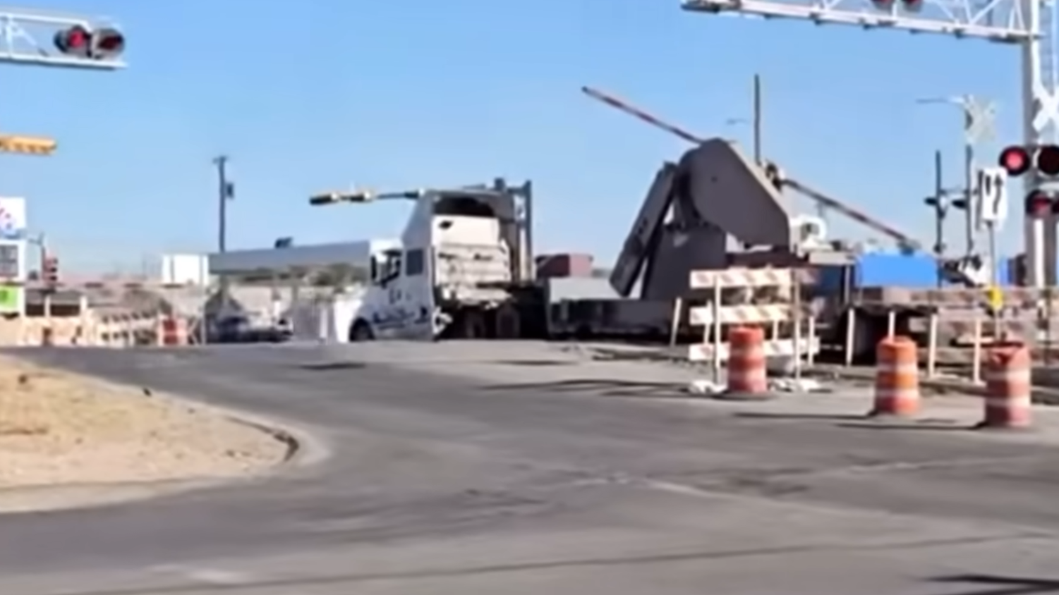A loader pulled a lowboy clear of an oncoming train