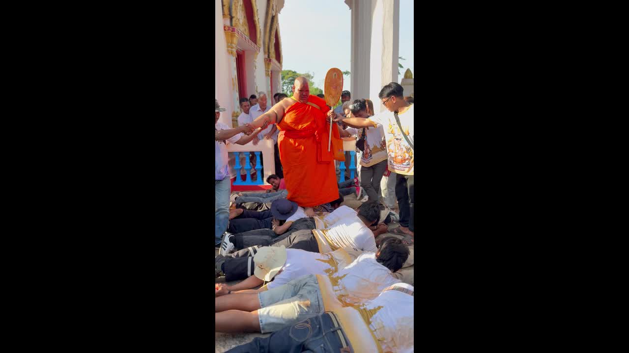 Obese Buddhist monk tramples over followers to 'bring them good luck'