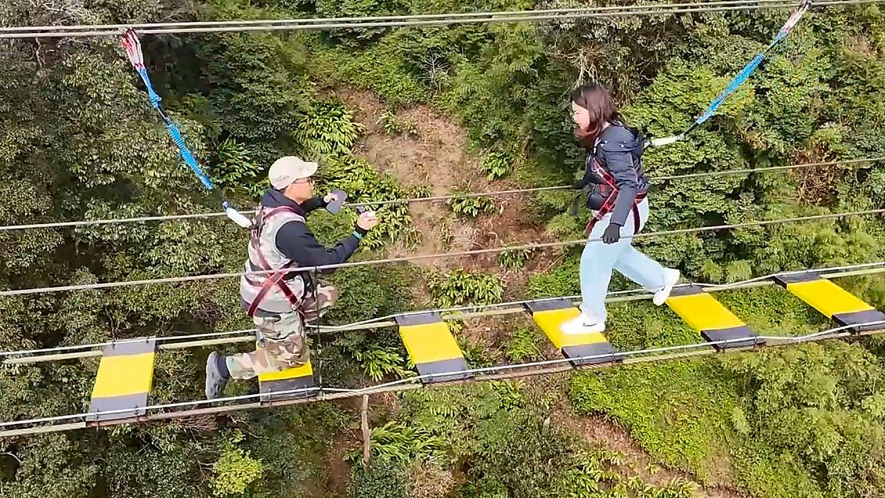 Fear and tears on sky-high rope bridge as boyfriend proposes mid-crossing