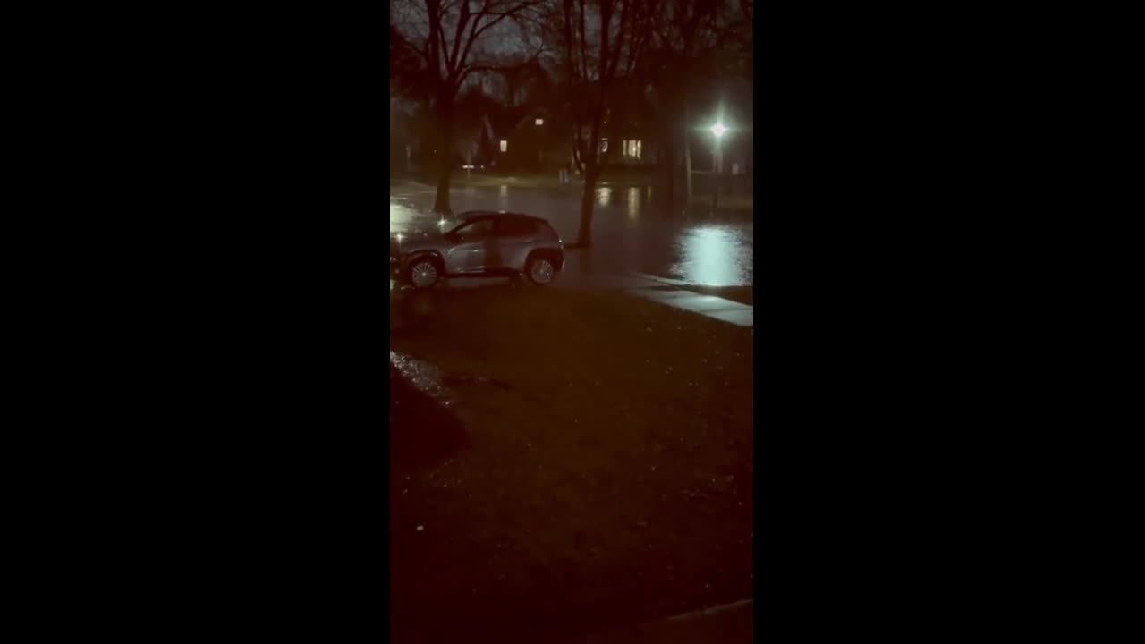 Heavy nighttime rain floods street in Chicago, Illinois, USA
