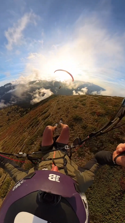Sunset paragliding flight over stunning landscapes