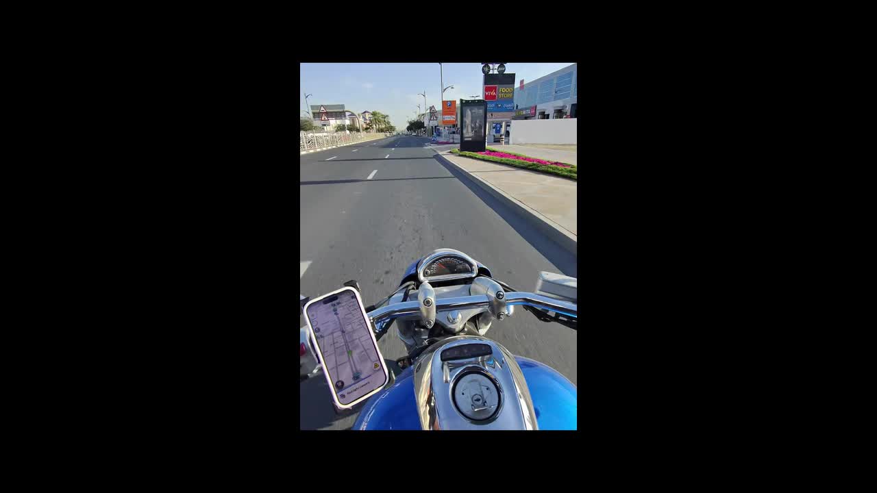 Helpless motorcyclist can only watch as iPhone falls onto road and is ...