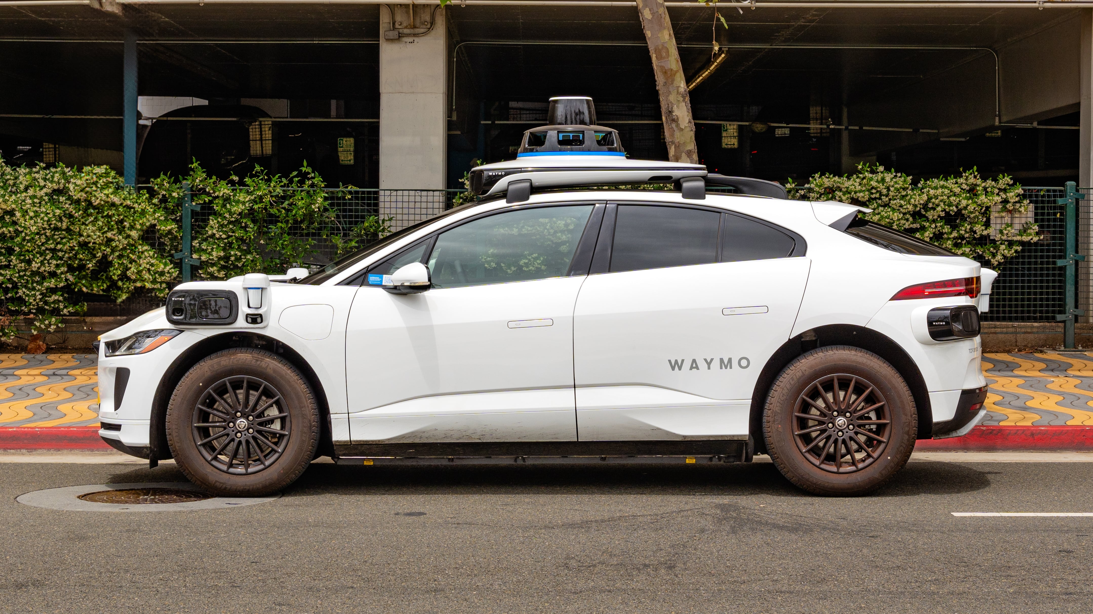 Waymo car drives on train tracks; passenger runs from vehicle
