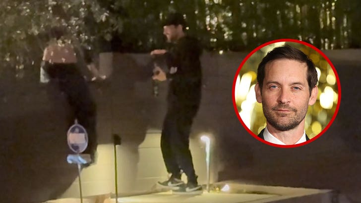 Tobey Maguire scales wall with beer in hand while out with mystery girl ...