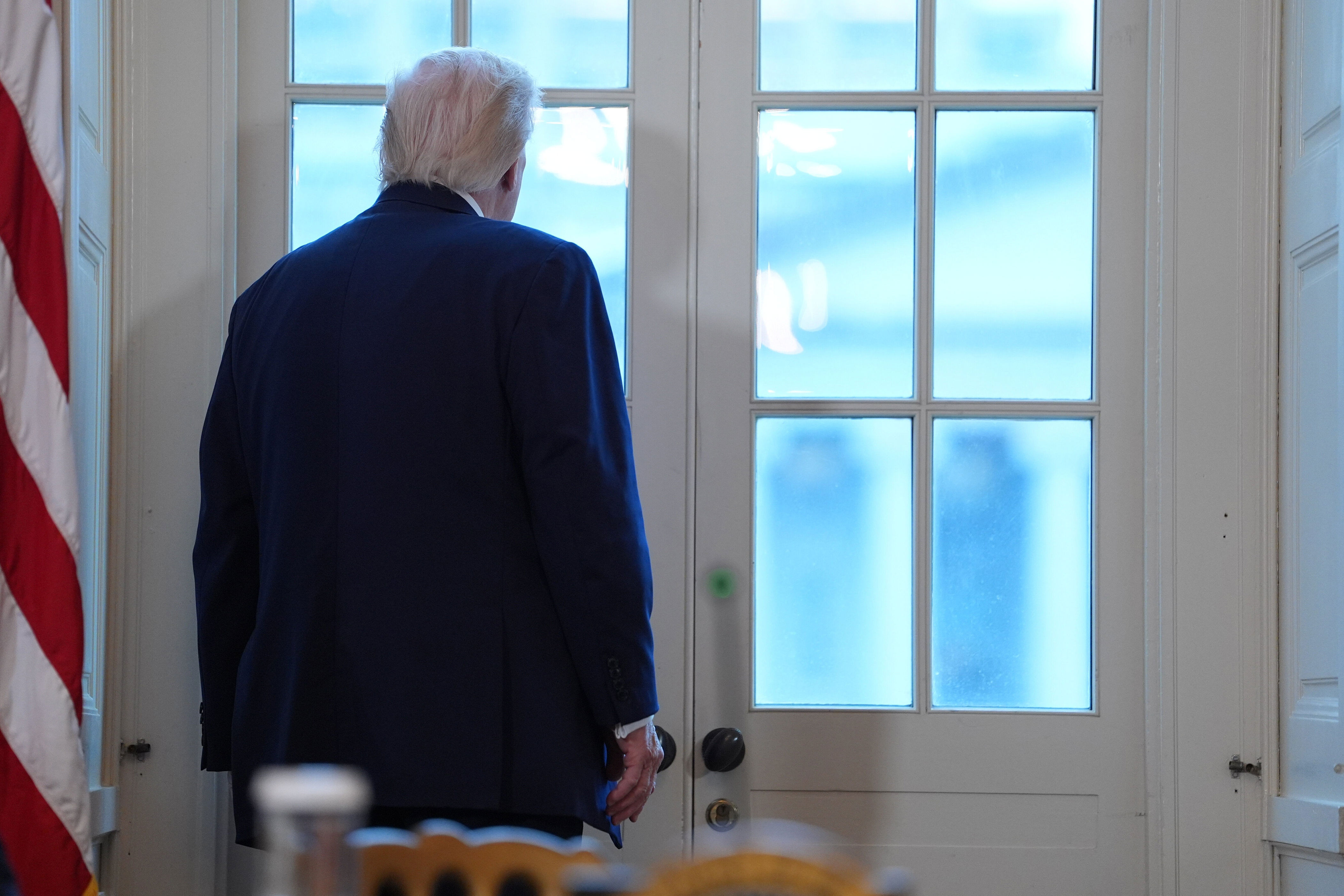 Trump gets up, walks away from meeting to stare out window at ballroom