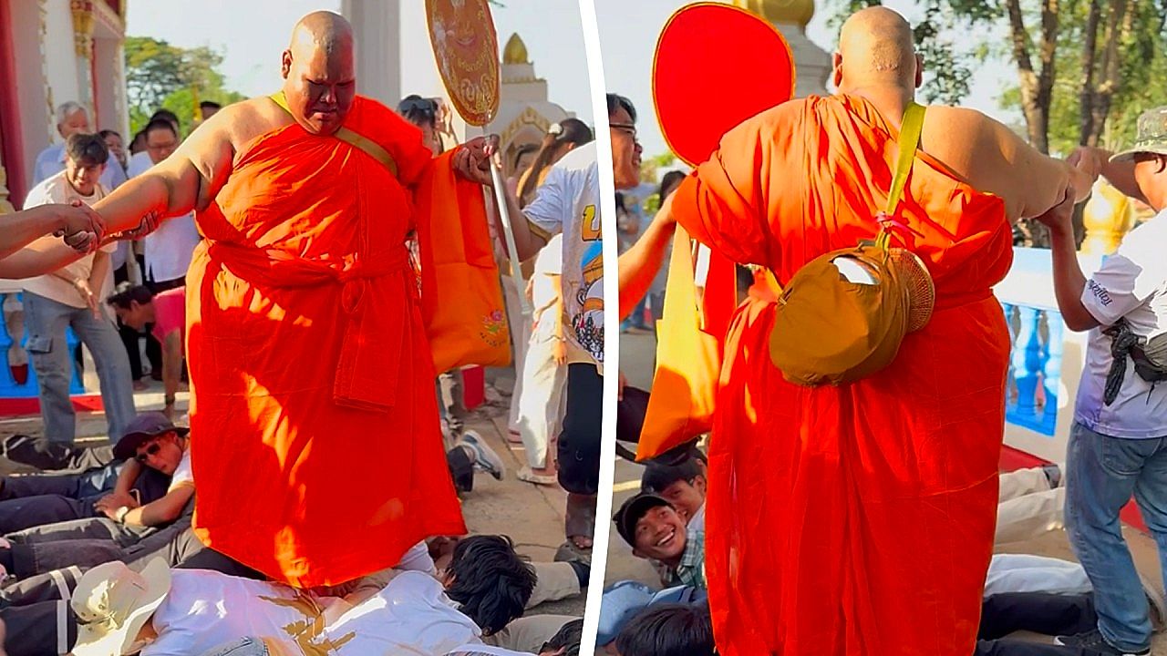 Monk walks across worshippers' backs during intense blessing ritual