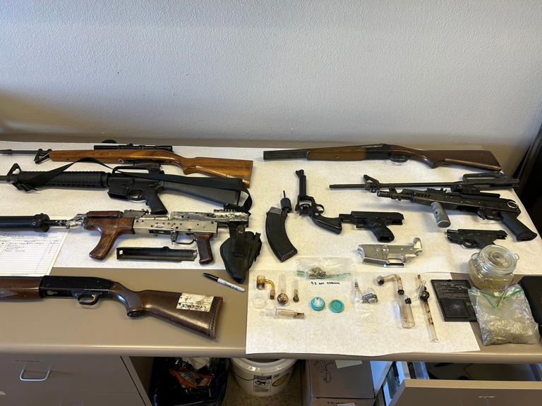 Man arrested after police allegedly find guns, drugs on man’s property