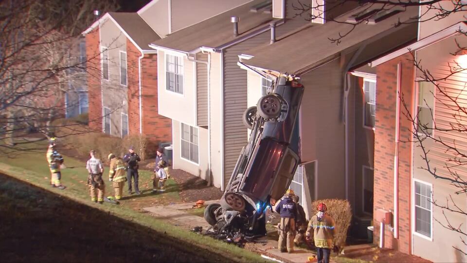 Pickup truck ends up vertical against building after crash in Robinson ...