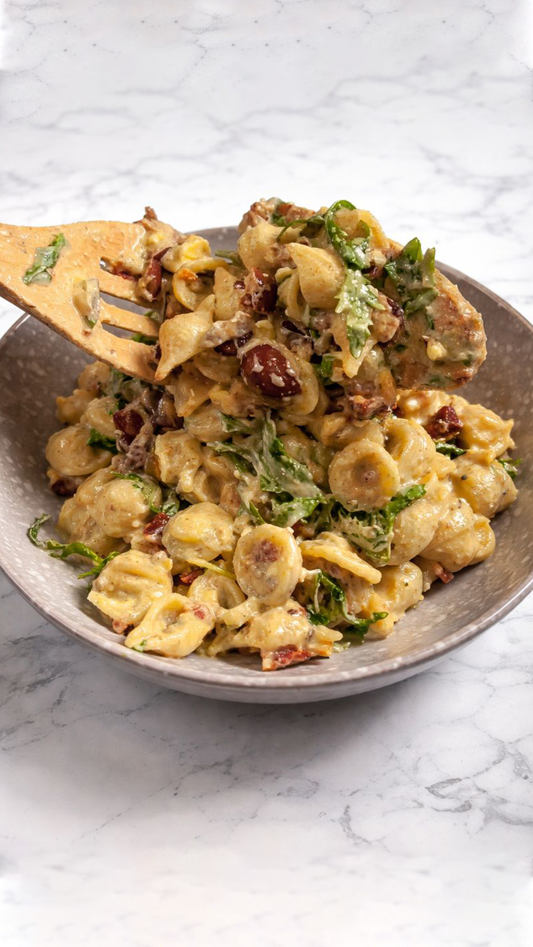 Cooking a vegan pasta salad with fresh ingredients