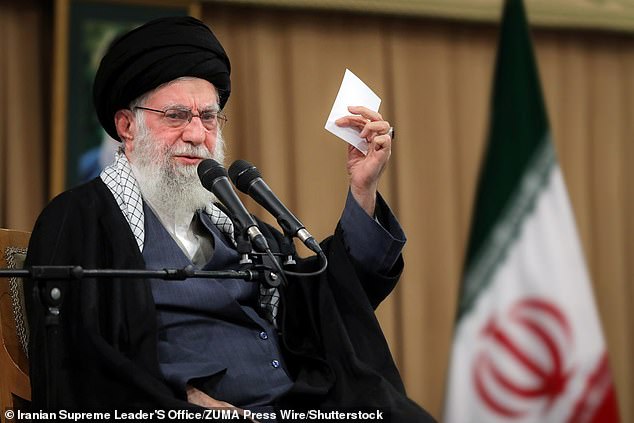 Iranian women light cigarettes by burning photos of Ayatollah Khamenei