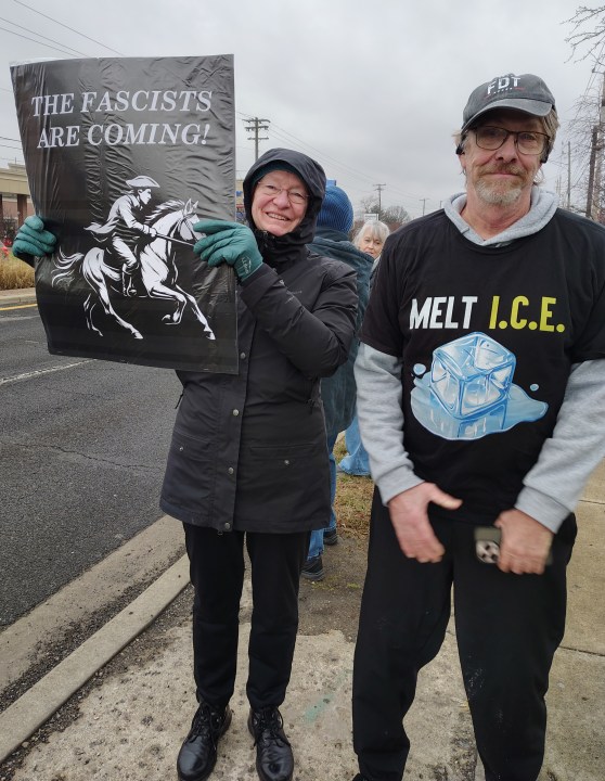 Anti-ICE protesters line 86th Street with signs