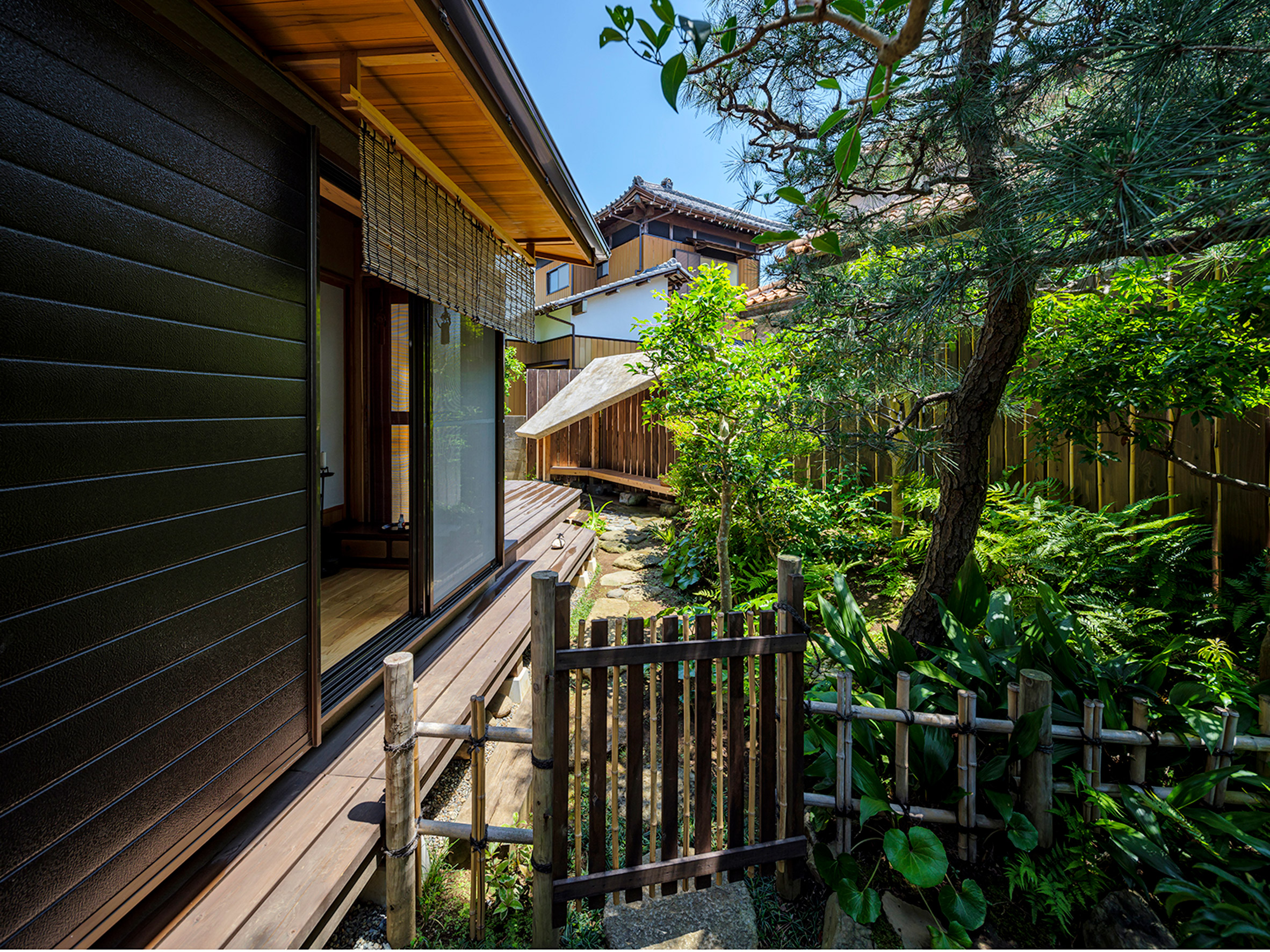 Sloping earthen roof tops waiting area for Japanese tea room by ...